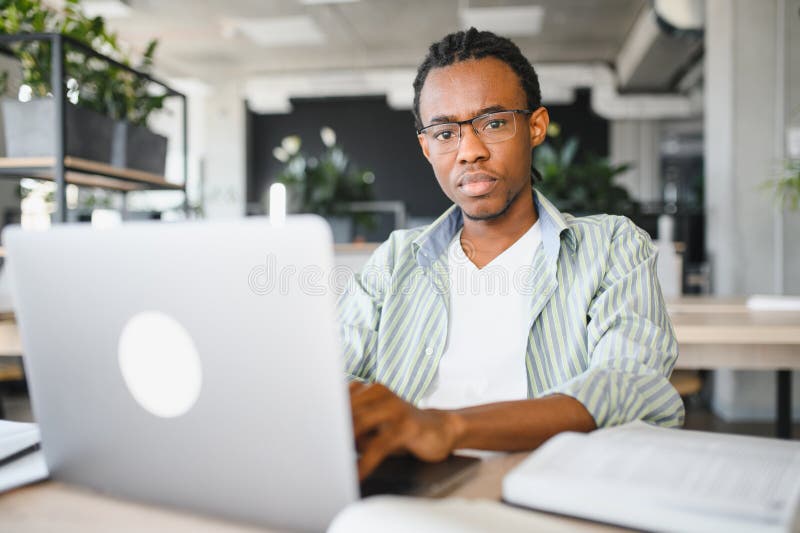 Focused University Student Studying on Laptop in Library Stock Image ...