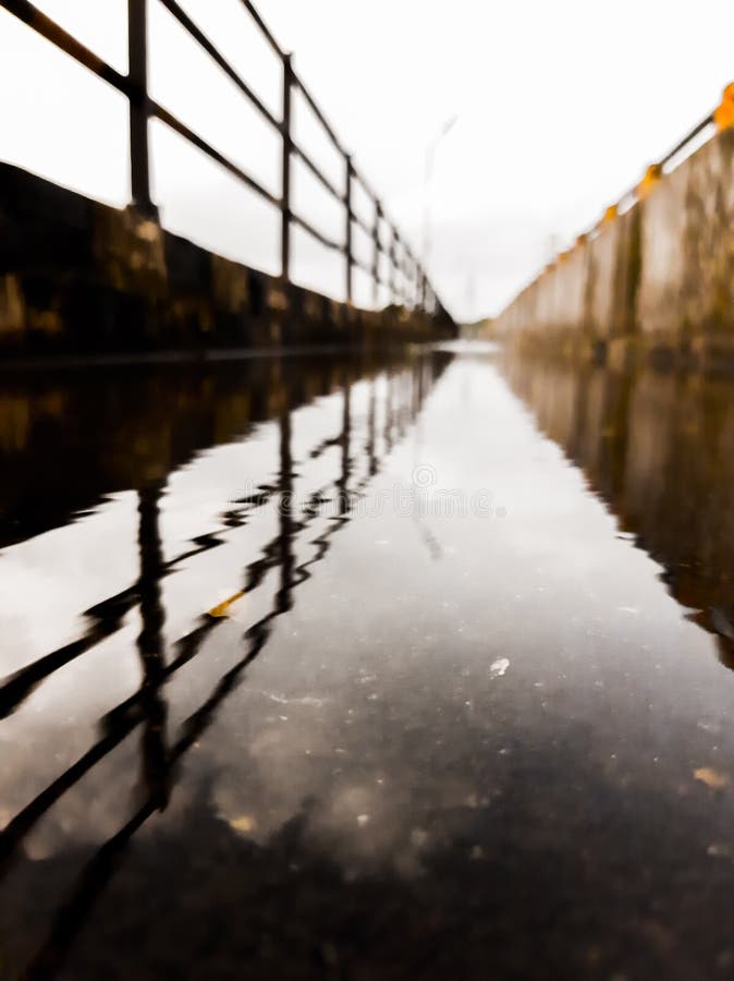 Focused at the Wate on Footpath Giving Inverted Image. Stock Image ...