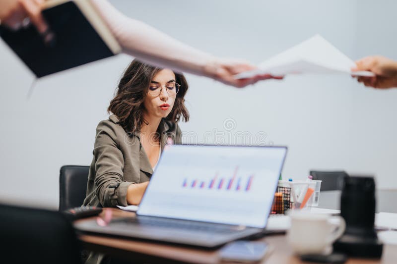 Busy Female Professional Multitasking at Work with Multiple Documents ...