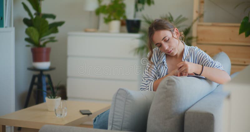 Focused Woman Taking Notes on Sofa Stock Footage - Video of comfortable ...