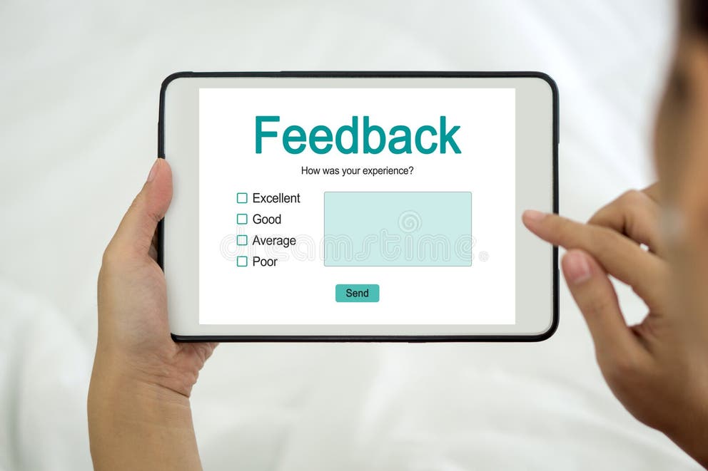 A Focused Woman is Using Her Tablet Computer, Displaying the Screen with the Prominently Visible ...