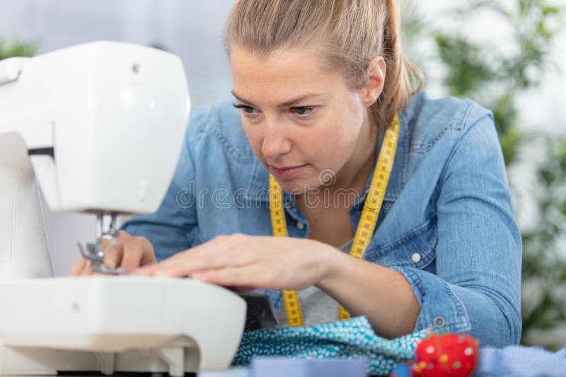 Focused Woman Using Sewing Machine Stock Photo - Image of seamstress ...