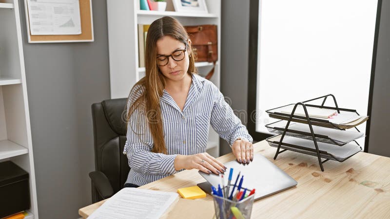 Focused Woman Working at Her Desk with Documents in a Modern Office ...