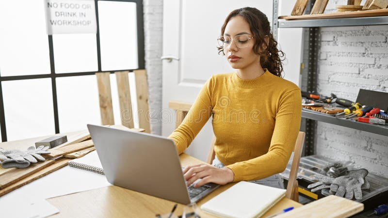 Focused Woman Working on Laptop in a Bright Carpentry Workshop Stock ...