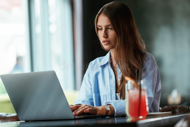 Focused at Work. Beautiful Woman with Laptop is in the Bar Stock Photo - Image of beautiful ...