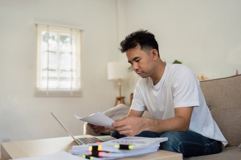 Focused Work and Concentration. a Man Reviewing Important Documents at ...