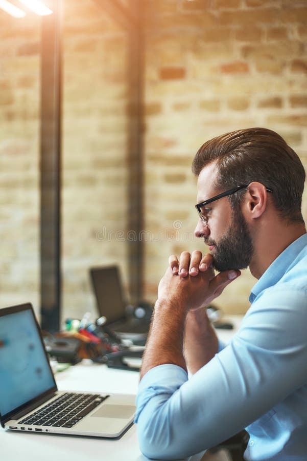 Focused on Work. Side View of Young Bearded Man in Eyeglasses and ...