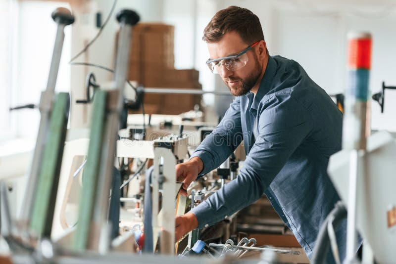 Focused by Working with Machine. Handsome Man is at the Factory of ...