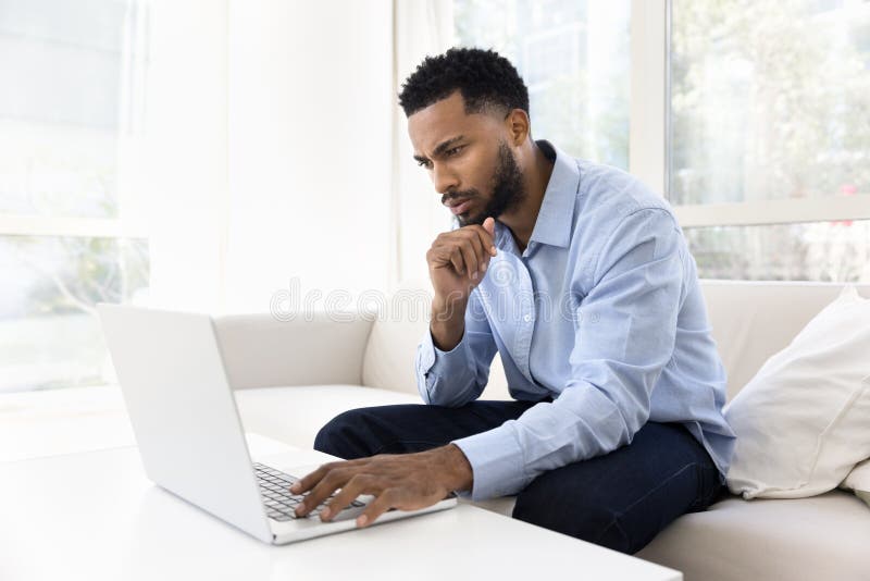 Focused Young African Freelancer Man Typing on Laptop at Home Stock ...
