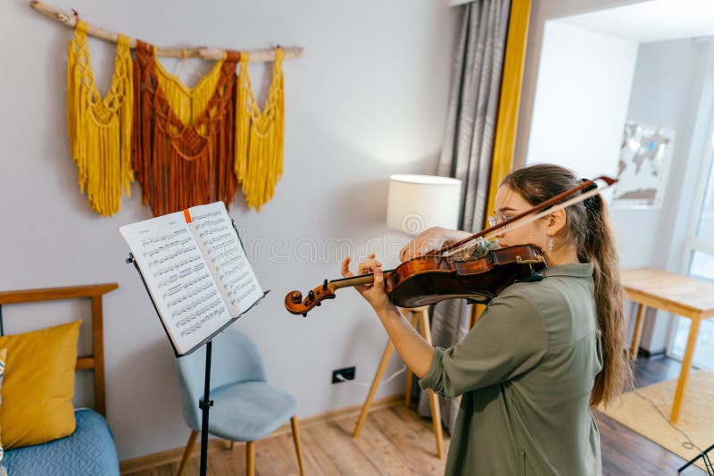Focused Young Artist Playing Violin and Studying Music Composition ...