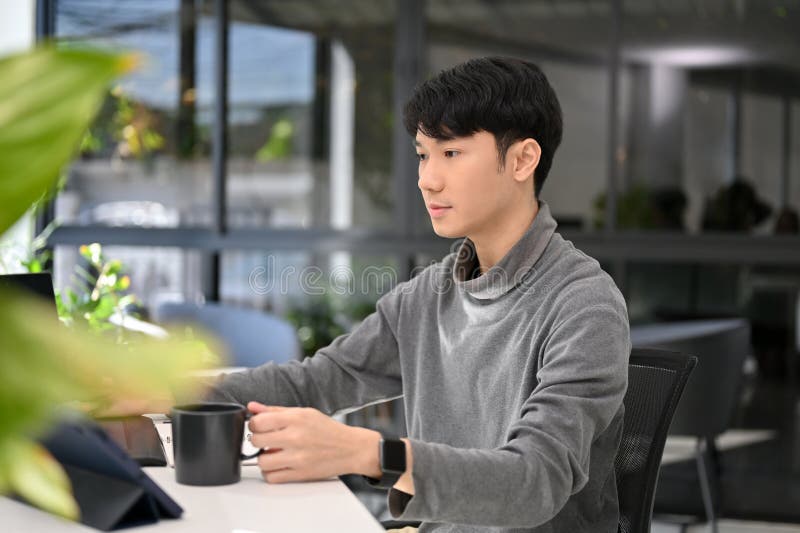 Focused Asian Male Graphic Designer or Website Developer Working at His ...