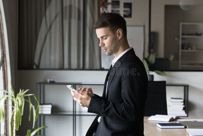 Focused Young Business Man in Formal Suit Typing on Smartphone Stock ...