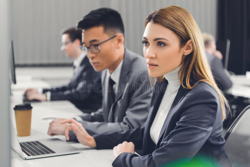 Focused Young Businesswoman Looking at Desktop Computer and Working ...