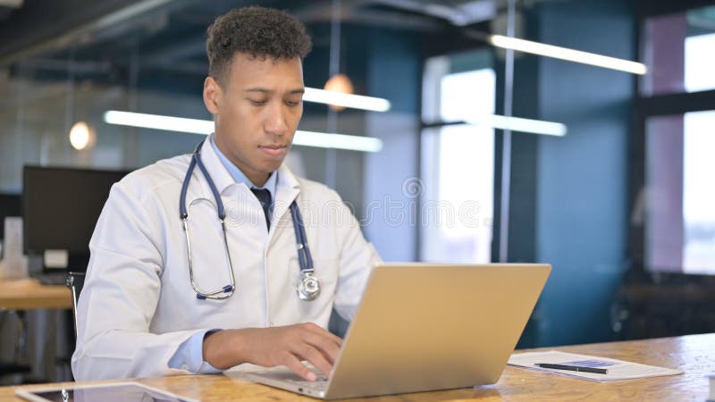 Focused Young Doctor Working on Laptop in Modern Office Stock Image ...