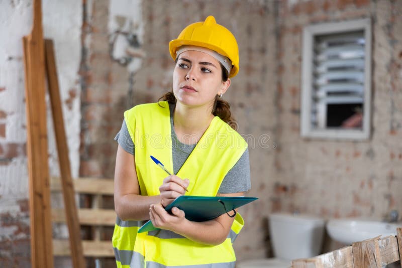 Female Civil Engineer Making Notes while Controlling Construction Site ...