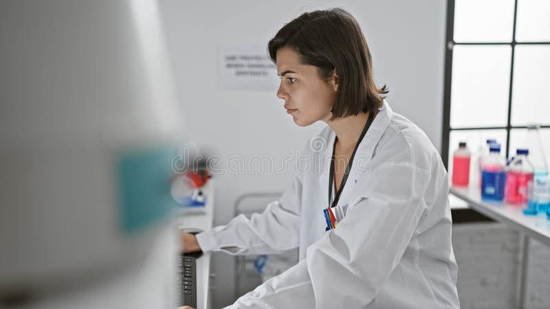 Focused Young Hispanic Woman, a Beautiful Scientist, Deeply Absorbed ...