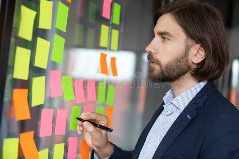 Focused Young Male Project Manager Analyzing Working Processes. Stock ...