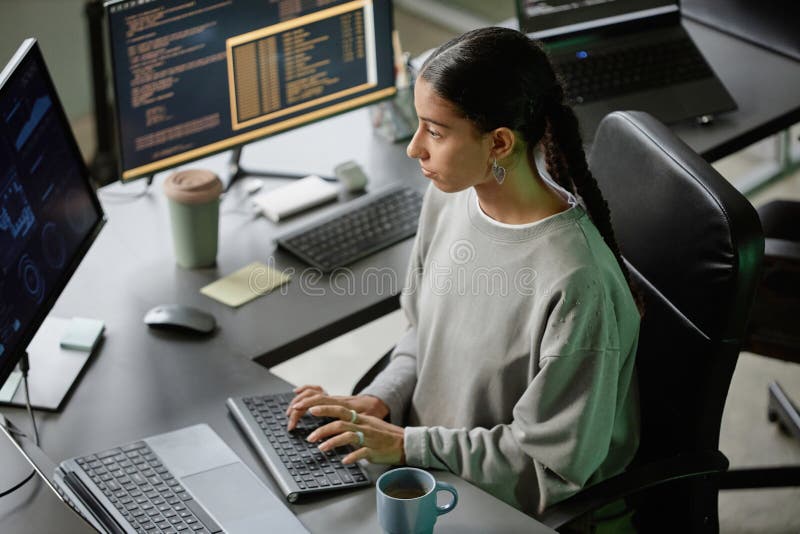 Focused Young Middle Eastern Female Coder Working on Computer in Office ... Focused Young Middle Eastern Female Coder Working on Computer in Office ...