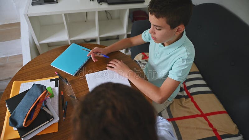 Young Boy Diligently Doing Homework at Home, Preparing for Back To ...
