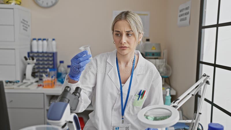 Focused Young Woman Scientist Analyzing a Specimen in a Modern ...
