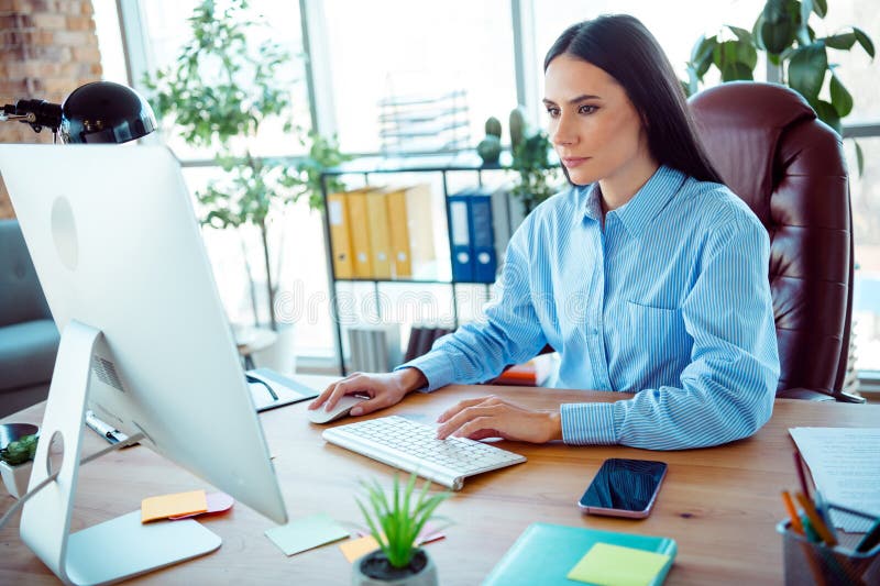 Young Professional Woman Working at a Desk in a Bright Office ...