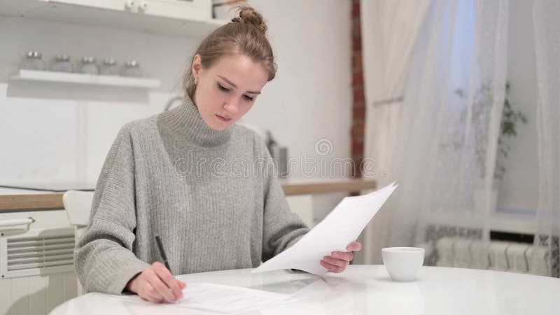 Focused Young Woman Writing on Paper at Home Stock Image - Image of ...