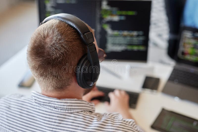 Focusing on Coding with Black Over-Ear Headphones Stock Photo - Image ...