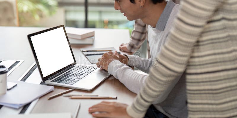Teamwork and Technology. Students Collaborating on a Laptop To Solve ...