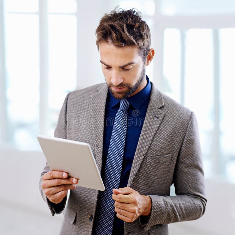 Focussed on Current Technology. Man in a Contemporary Suit Holding a ...