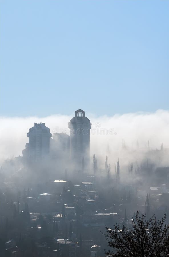 Fog Over the City. City is Covered with Mist in Sunlight and Blu Stock ...