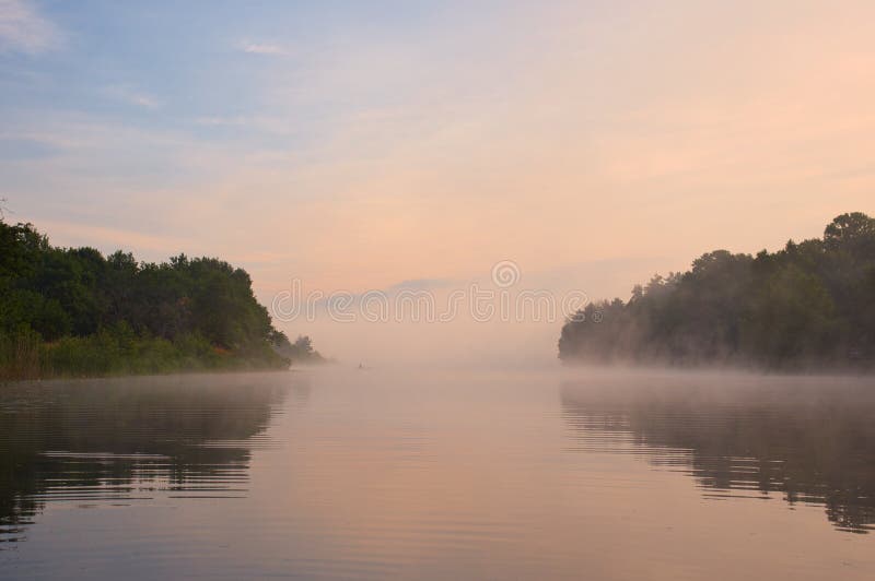 Fog Over the River at Sunset a Fisherman in a Boat on the Water Stock ...