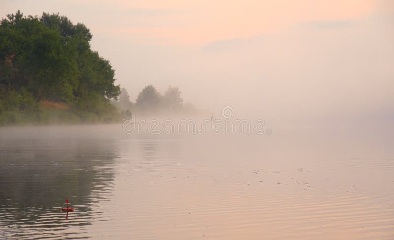 Fog Over the River at Sunset a Fisherman in a Boat on the Water Stock ...