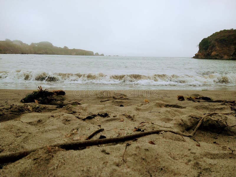 Foggy beach waves stock image. Image of waves, geology - 232320199