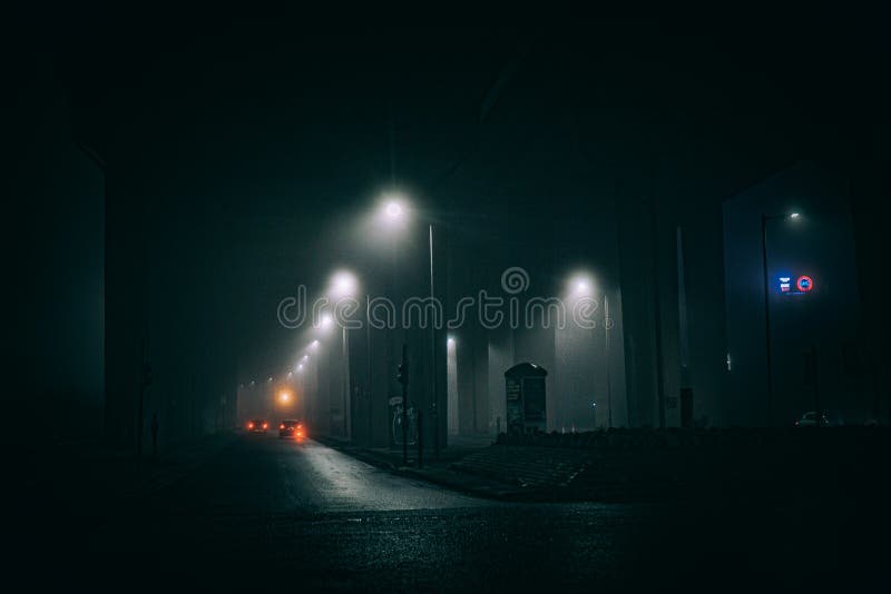 Foggy City Centre Scene Underneath Bridge with Traffic and Lights at ...