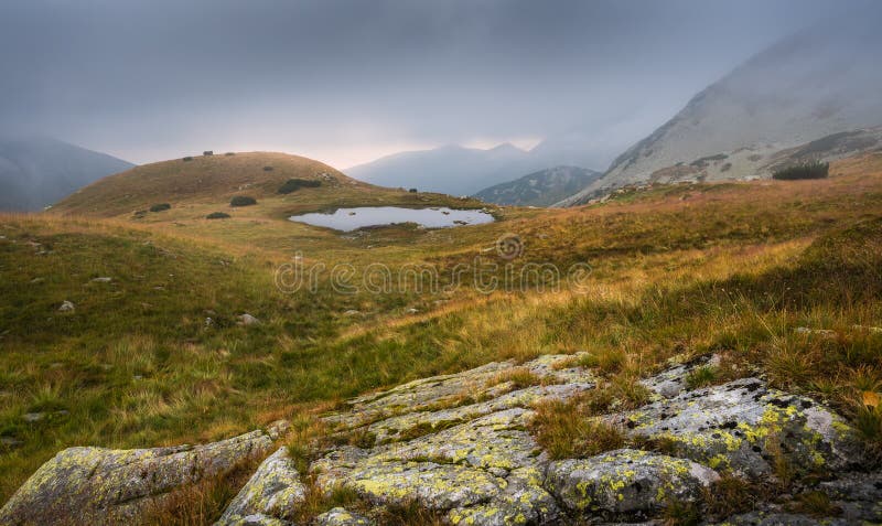 Foggy Mountain Landscape with a Tarn at Sunset Stock Photo - Image of ...