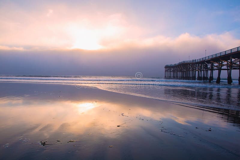 Foggy sunset on the coast stock photo. Image of beach - 266055472