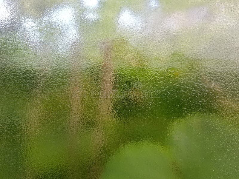 Foggy Window Glass with Raindrops and Green Nature Background Stock ...