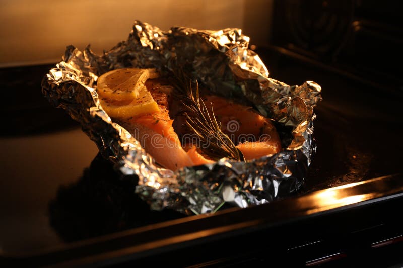Foil with Fish in Oven, Closeup. Baking Salmon Stock Image - Image of ...