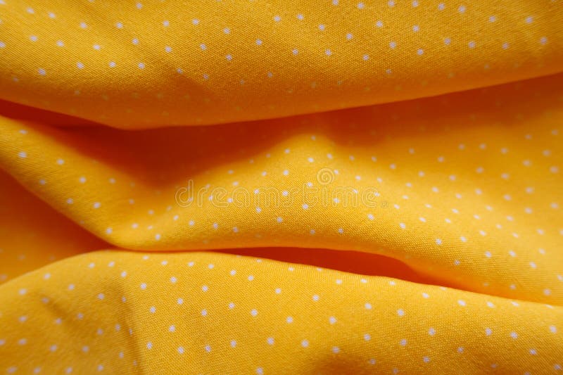Folded Amber Yellow Fabric with White Pin Dot Pattern Stock Photo ...