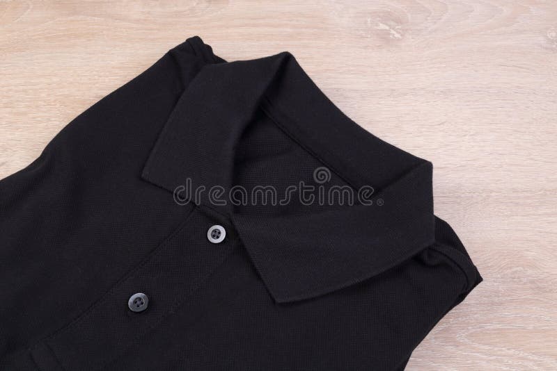 Folded black polo shirt stock photo. Image of wooden - 140539084