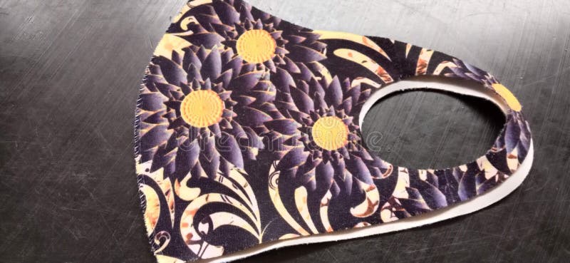 The Folded Cloth Masks with Batik Shapes and Motifs on the Table are ...