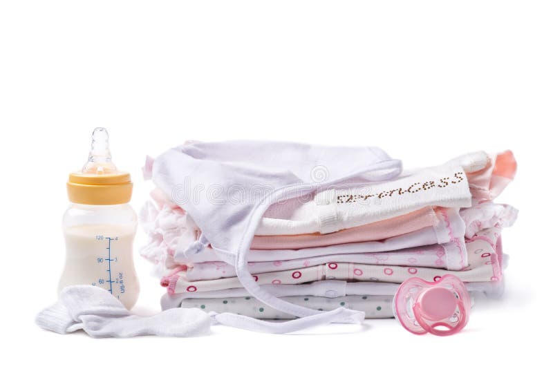 Folded Clothes for Babies with a Bottle of Milk and Pacifier Stock ...