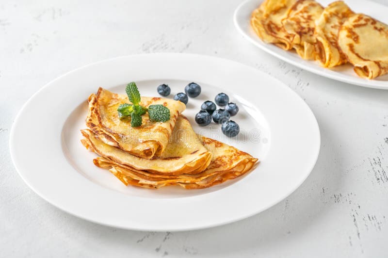 Folded crepes on the plate stock photo. Image of dinner - 210149240