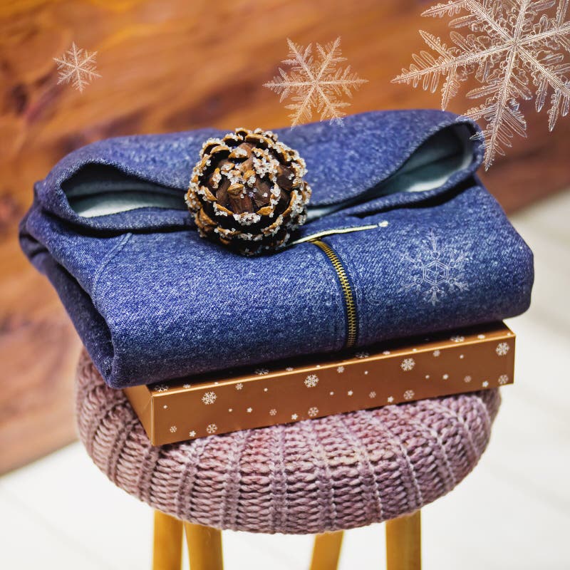Folded Denim Jacket on a Knitted Chair and a Gift Box Stock Photo ...