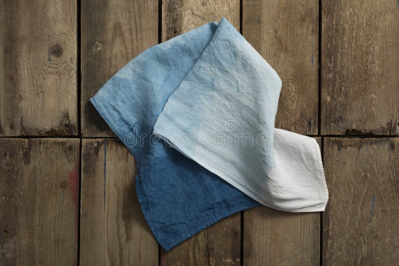 Folded Gradient Blue Cloth or Linen on Wooden Panel Surface Stock Photo ...