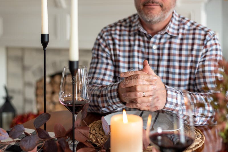 Folded Hands at a Holiday Dinner Table Stock Photo - Image of candles ...