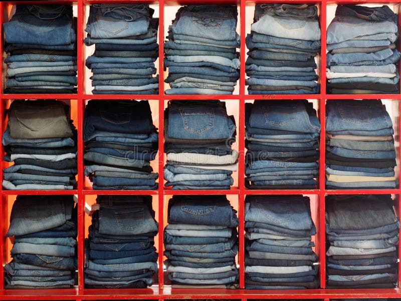 Folded Jeans Kept on Red Shelves. Stock Image - Image of pile, indoor ...