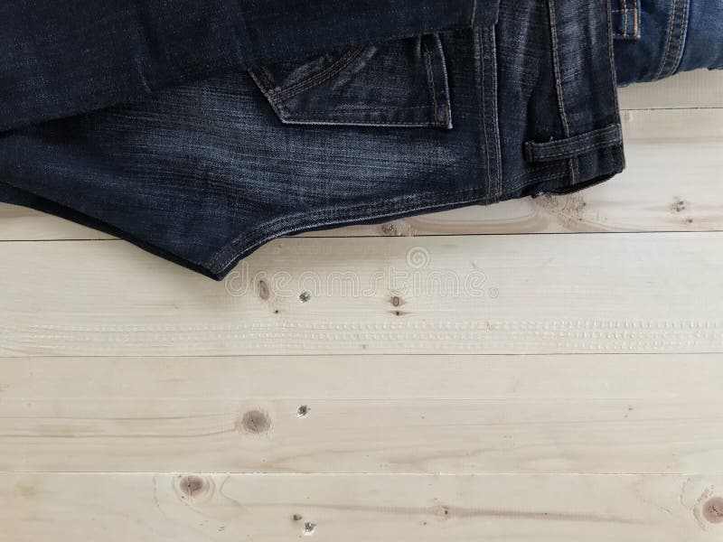 Folded Jeans on Wood Floor with Space for Writing Stock Image - Image ...