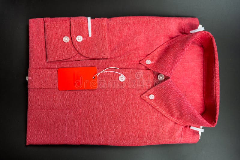 A Folded Man Red Shirts with Red Label Stock Photo - Image of quality ...