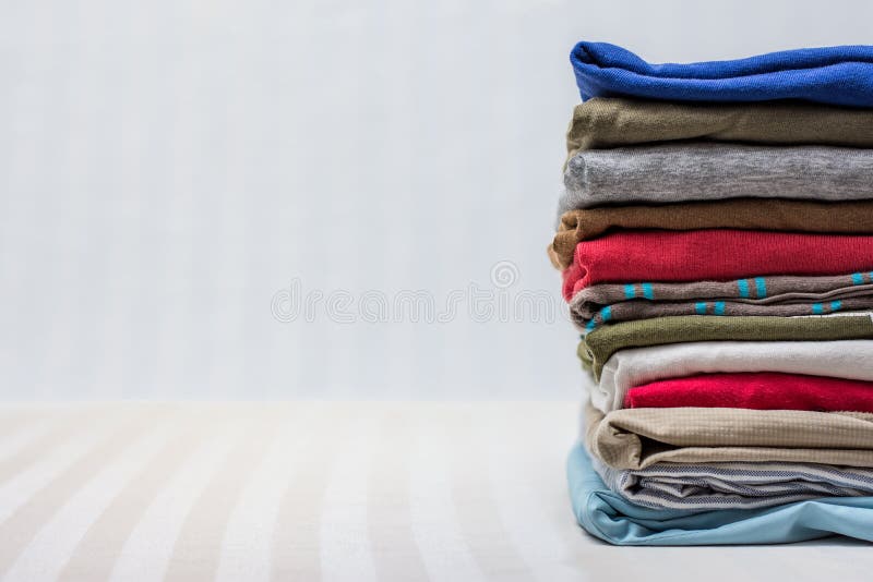 Folded Clothing Next To Pile Of Unfolded Clothes. Stock Image - Image ...